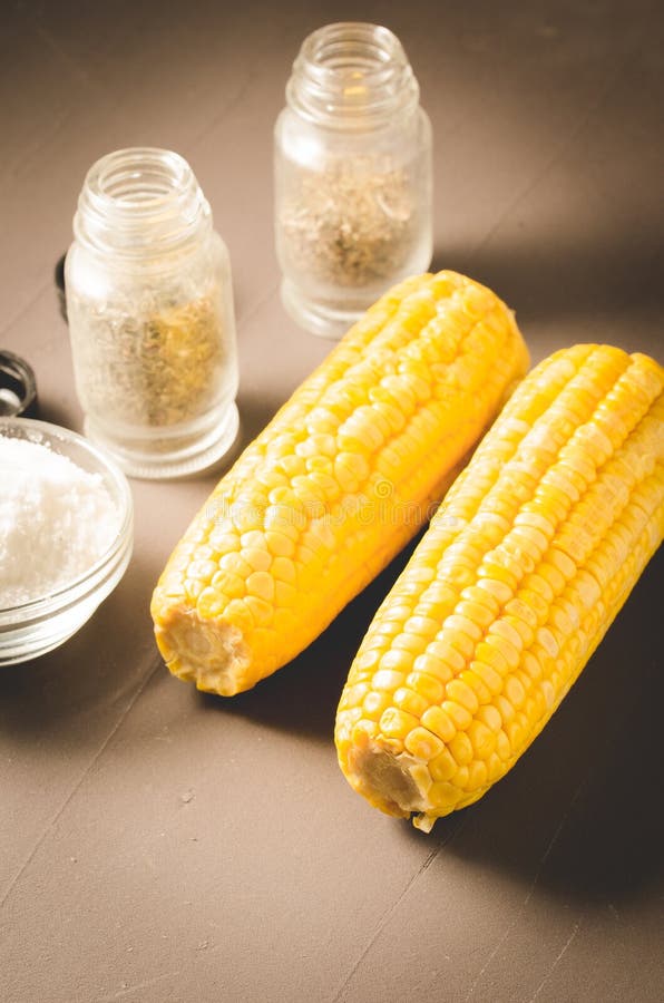 Corn. Boiled Corn with Salt and Seasonings on a Dark Table. Selective ...