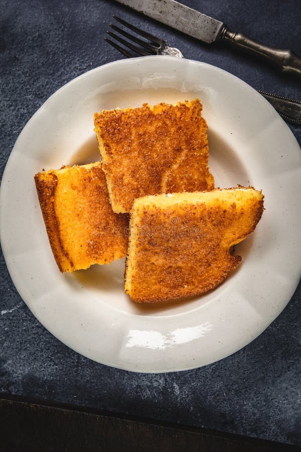 Corn Bread Squares Slices in White Plate on Dark Blue Background Stock ...