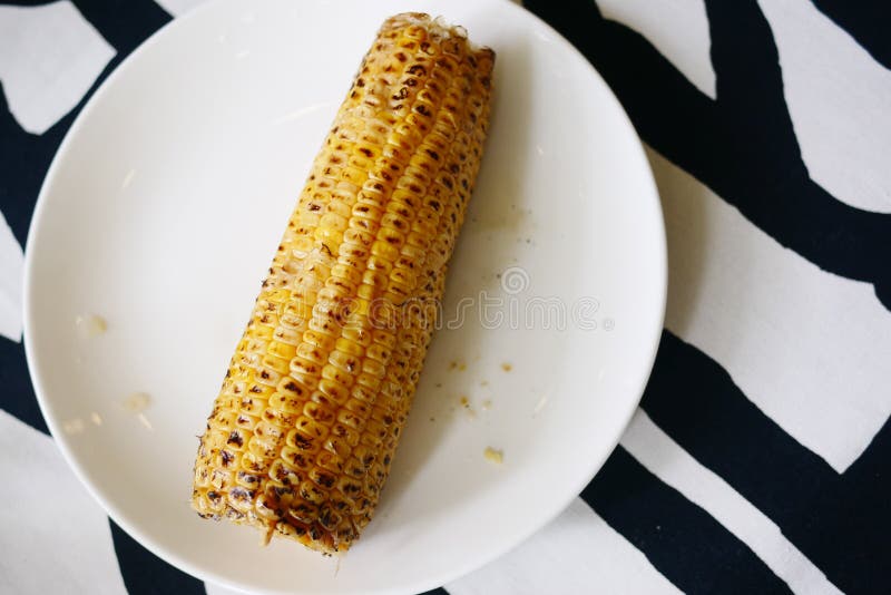 Corn Cob on White Plate on Table Stock Photo - Image of vibrant, white ...