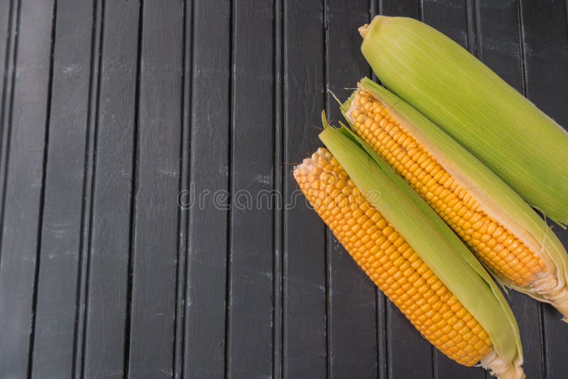 Corn Cobs on a Black Wooden Base Stock Photo - Image of produce ...