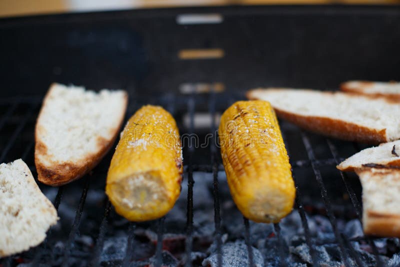 Corn Cobs Put on the Barbecue with Bread on a Summer Holiday Stock ...