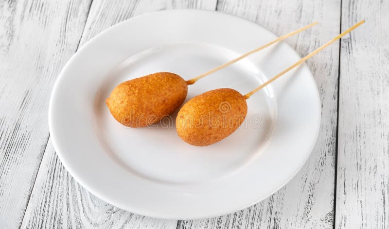 Corn dogs on white plate stock image. Image of group - 201162581