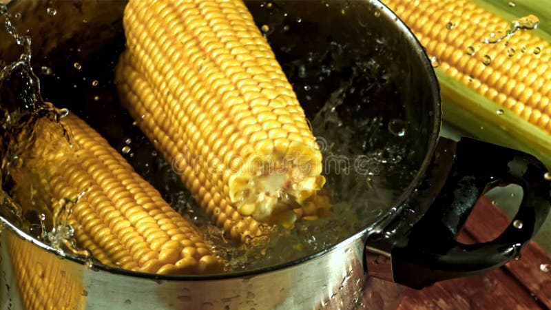 Corn Falls into the Pan with Splashes. Filmed on a High-speed Camera at ...