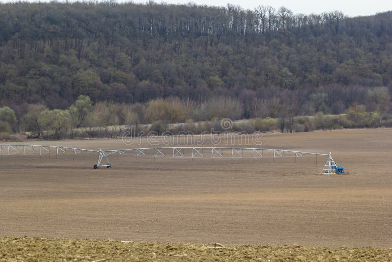 Corn Field in Spring with Irrigation System for Water Supply ...