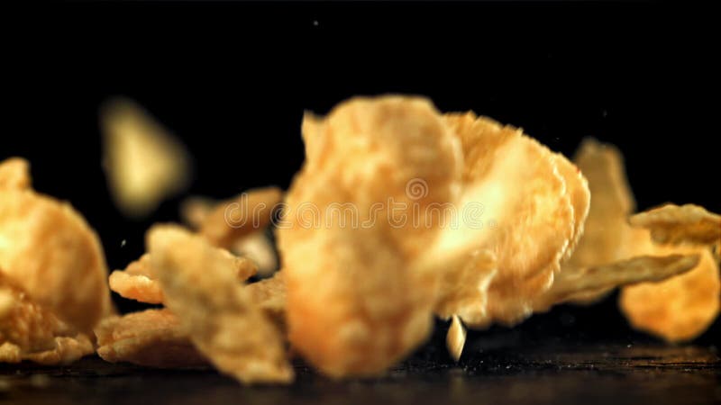 Corn Flakes Falling on Black Background. Filmed on a High-speed Camera ...