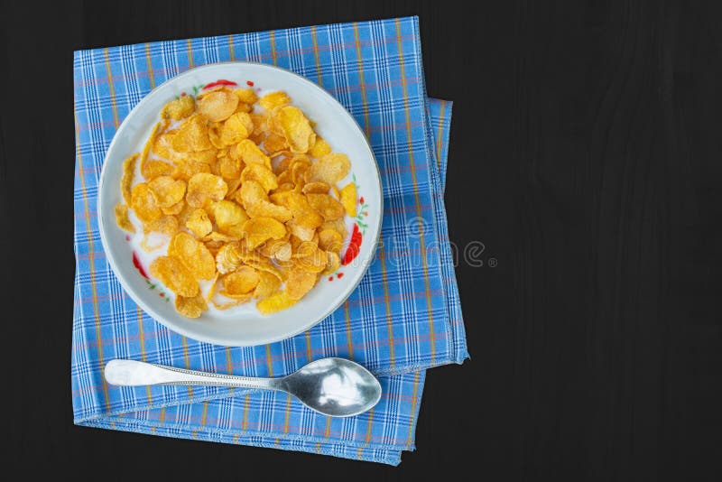 Corn Flakes with Milk on Black Wood Table Top View Stock Photo - Image ...