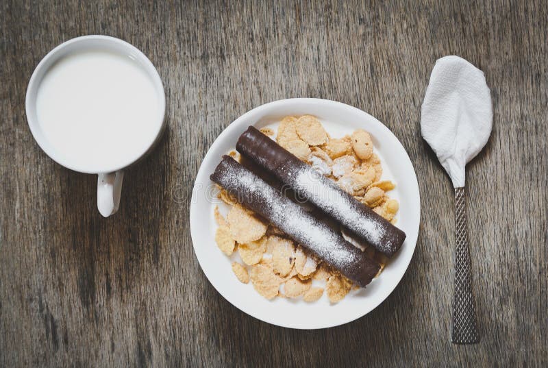 Corn Flakes with Two Chocolate Wafer Rolls and Milk Mug for Morning ...