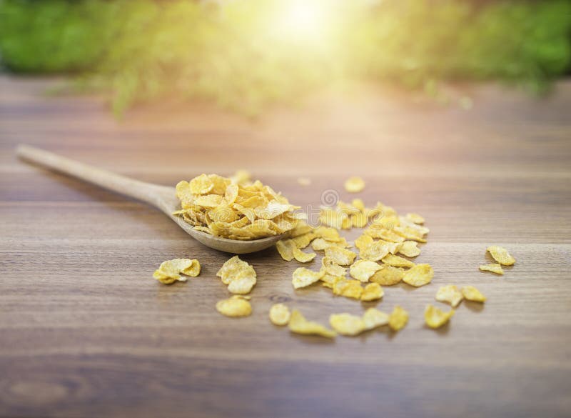 Corn flakes on wood table stock photo. Image of health - 95190562