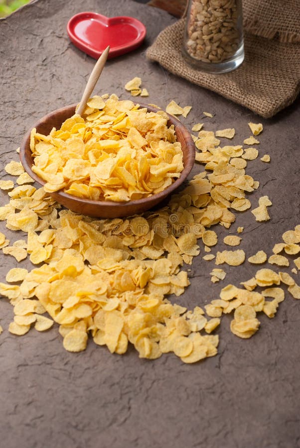 Corn Flakes in Wooden Bowl with Spoons and Red Heart Stock Photo ...