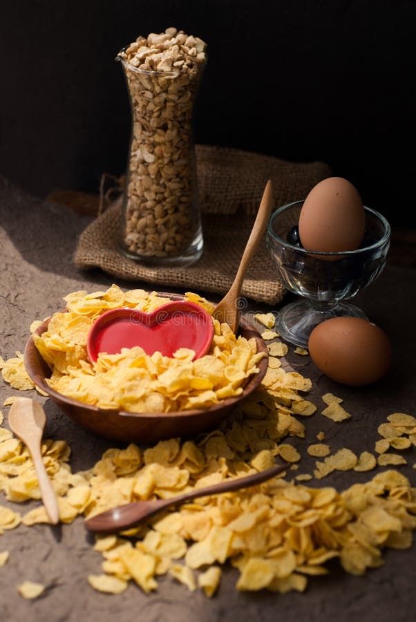 Corn Flakes in Wooden Bowl with Spoons and Red Heart Stock Image ...