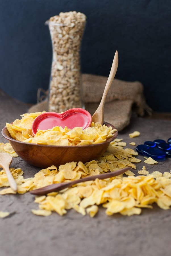 Corn Flakes in Wooden Bowl with Spoons and Red Heart Stock Photo ...