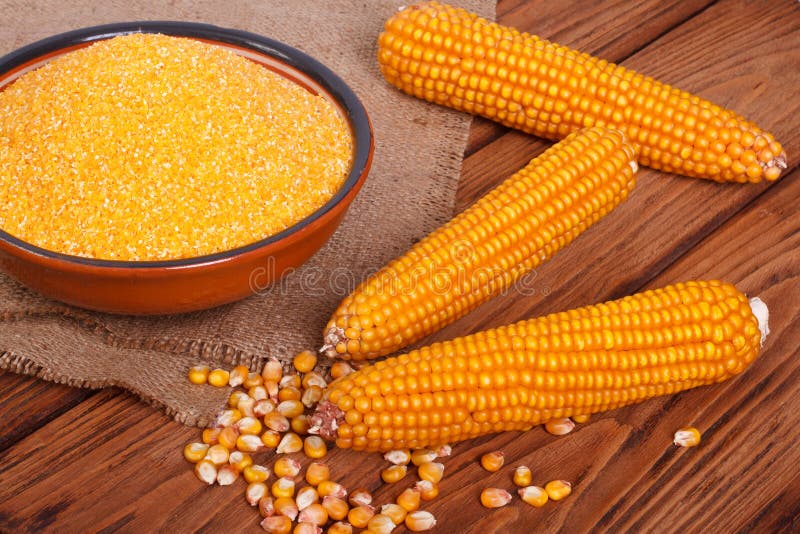 Corn Groats in a Bowl, Whole Grain and Cob on a Wooden Stock Image ...