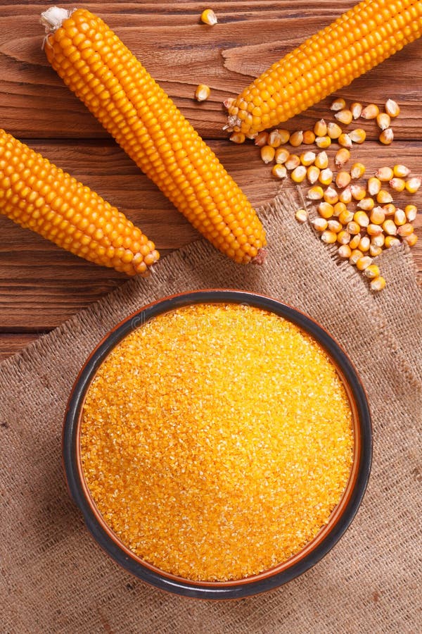 Corn Groats in a Bowl, Whole Grain and Cob on a Wooden Table. Stock ...