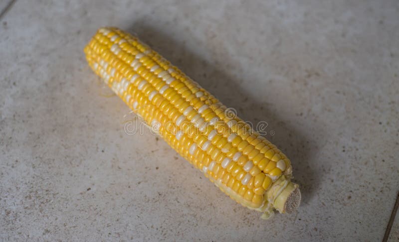 Corn Lies Atop Ceramic Spotted Surface without Packaging. Visible ...
