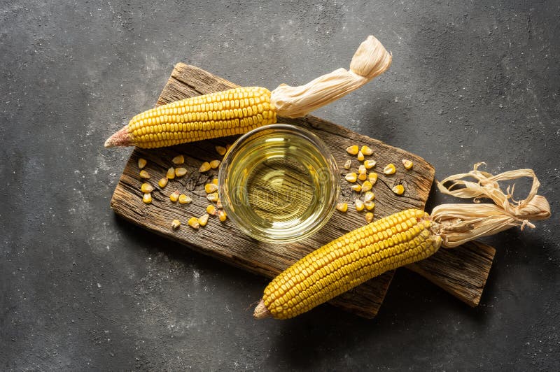Corn Oil in Glass Bowl with Dried Corn Groats and Kernels on Rustic ...