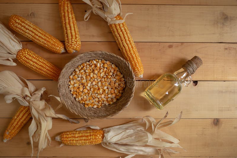 Corn Oil and Corn Kernels on Natural Pattern Wood Background Stock ...