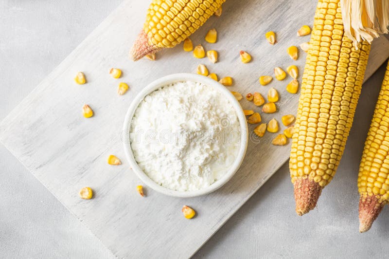Corn Starch in Bowl and Spoon with Dried Corn Groats, Kernels on Rustic ...