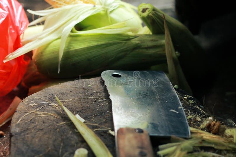 Corn, a Wooden Placemat and a Knife for Cutting Corn and Peeling Corn ...