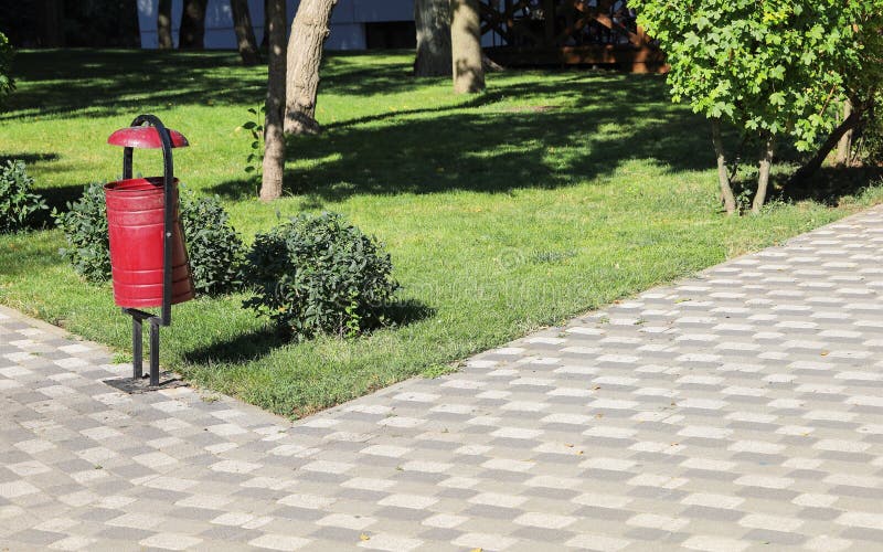 Corner of the Bend of the Paved Path in the Park and the Red Trash Bin ...