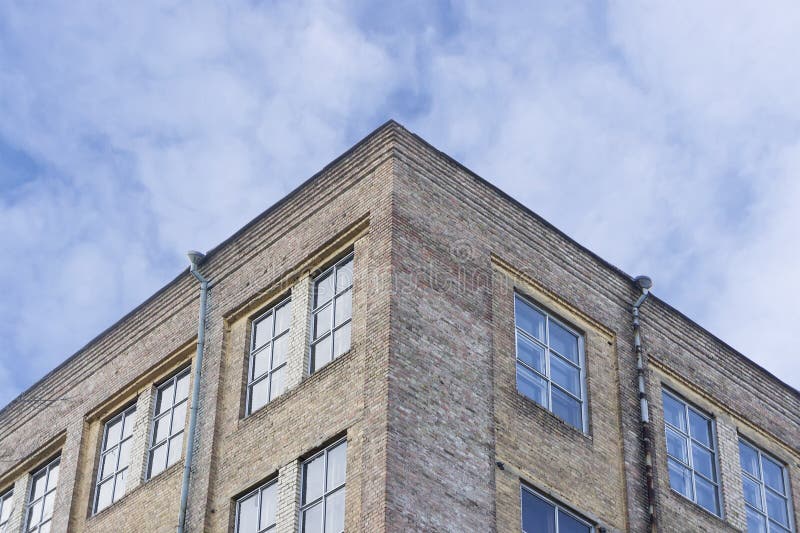 Corner of a Building Against a Blue Sky in the Spring. Stock Image ...