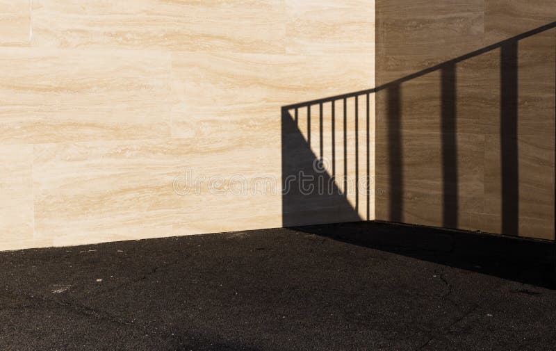 Corner of a Building Seen through Asphalt with a Shadow of a Fence on ...