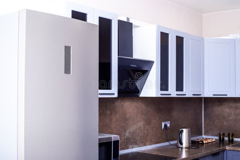 Corner Kitchen Set with Dark Worktop and Large Refrigerator Stock Image ...