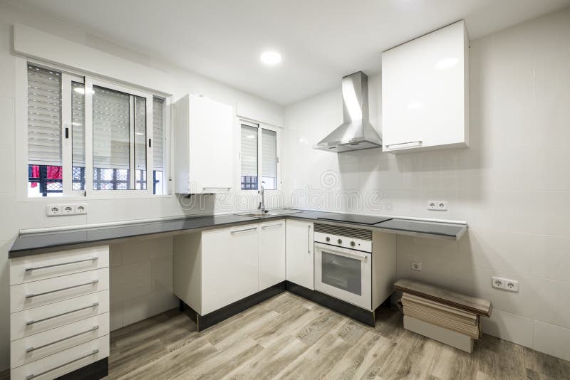 Corner Kitchen with White Cabinets and Missing Some Appliances with ...