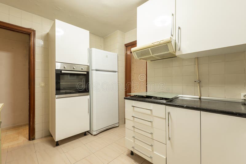 Corner of an Old Kitchen with White Furniture, a Column with an Oven ...