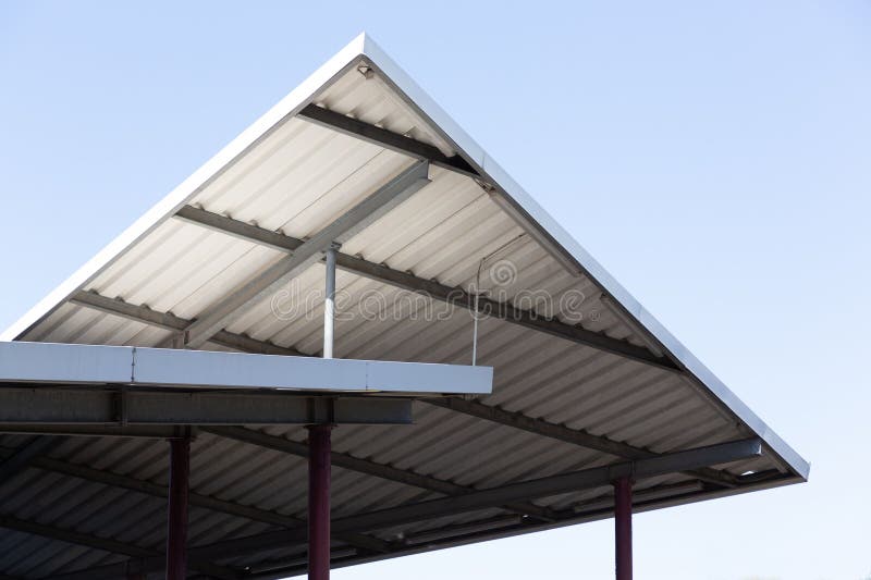 The Corner of an Old Roof Structure Rises into the Blue Sky, Forming ...