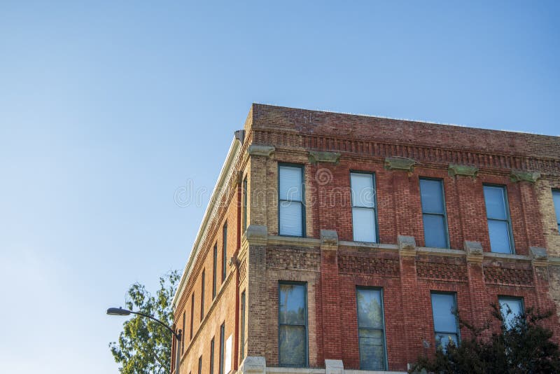 The Corner of a Red Brick Buildings Surrounded by Lush Green Trees and ...
