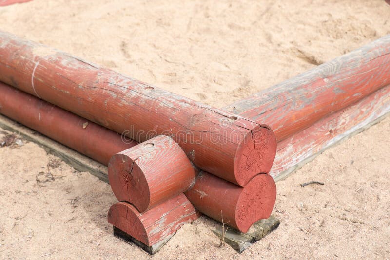 Corner of Red Logs in the Sand Stock Image - Image of barn, house: 94079157