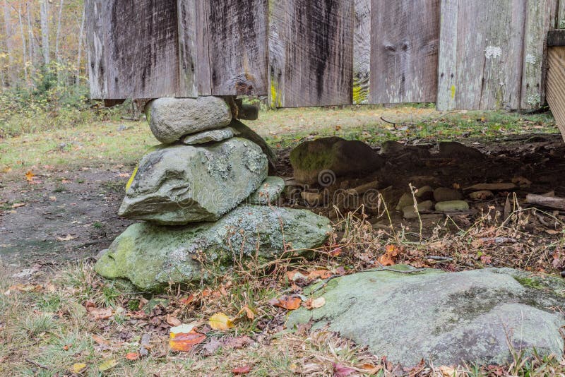 Stacked Stone Foundation Pier Beneath a Board and Batten Wall Stock ...