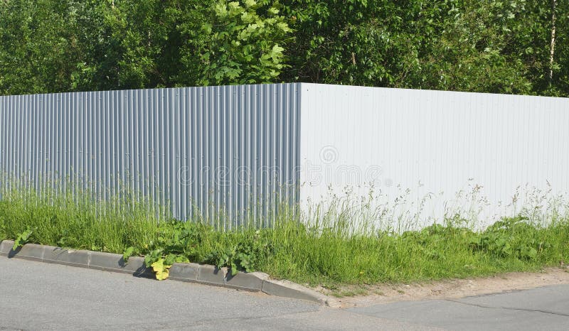 Corner of a Solid Gray Metal Fence Hiding Green Trees Stock Image ...