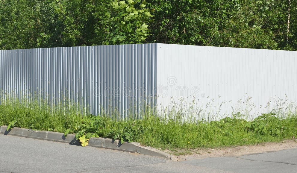 Corner of a Solid Gray Metal Fence Hiding Green Trees Stock Image ...