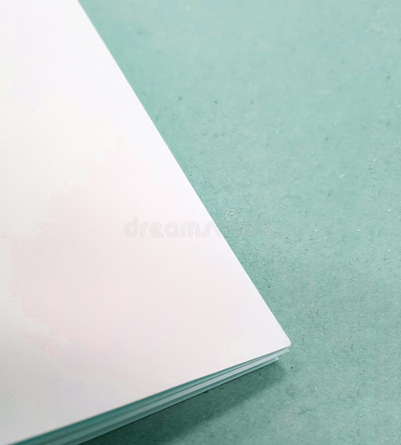 A Corner of a Stack of White Paper Sheets Lies on a Green Background ...