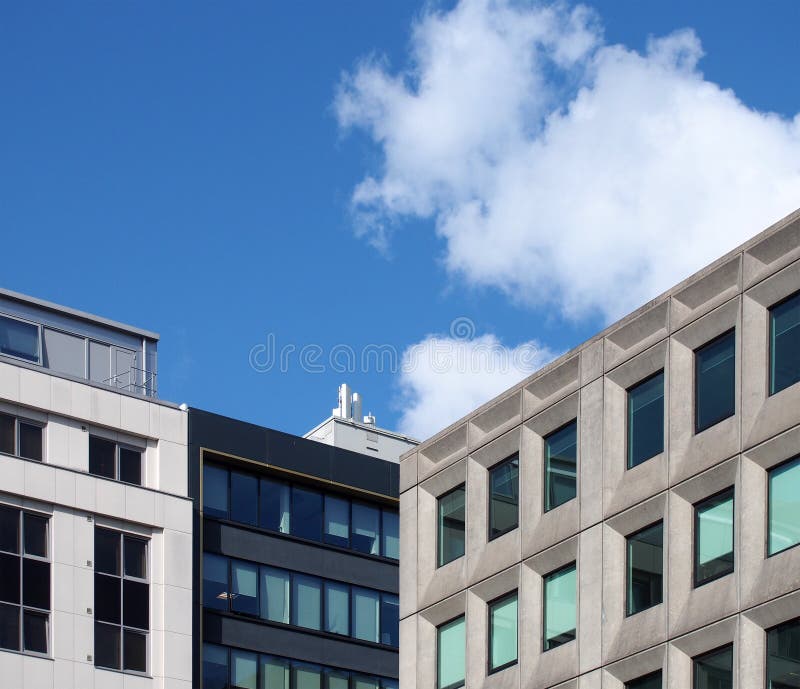 Corner View of a Group of Modern Office Buildings Against a Blue Sky ...