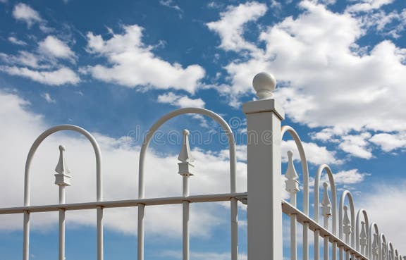 Corner of White Wrought Iron Fence Stock Photo - Image of post, clouds ...