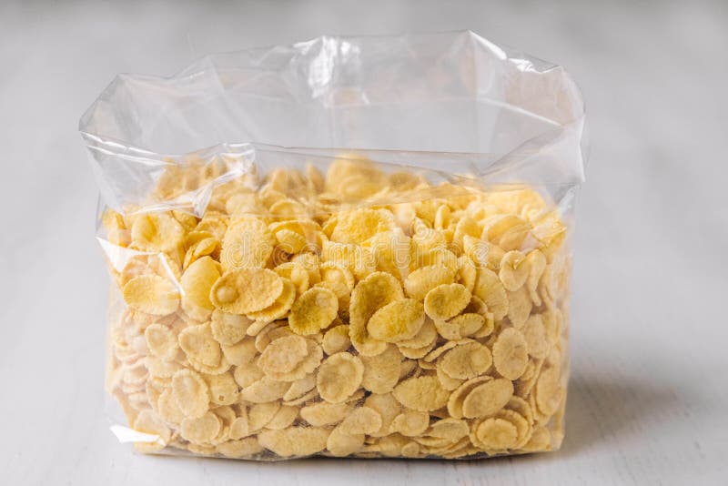 Cornflakes in Plastic Bag on White Wooden Surface. Place for Your Text ...