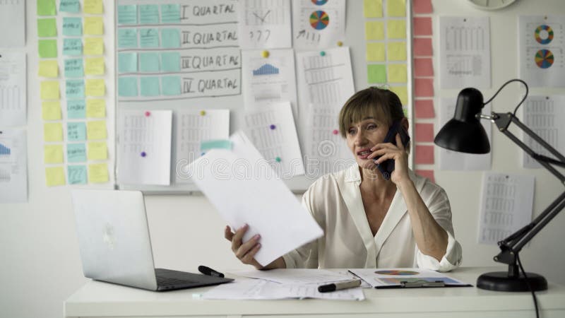 Corporate Communication. Elderly Female Manager Working with Papers and ...