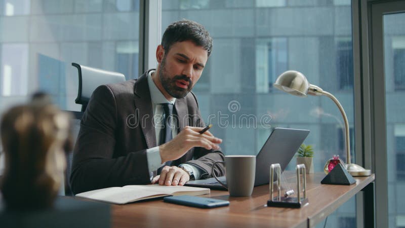 Corporate Employee Talking Webinar Sitting Office Desk Making Notes