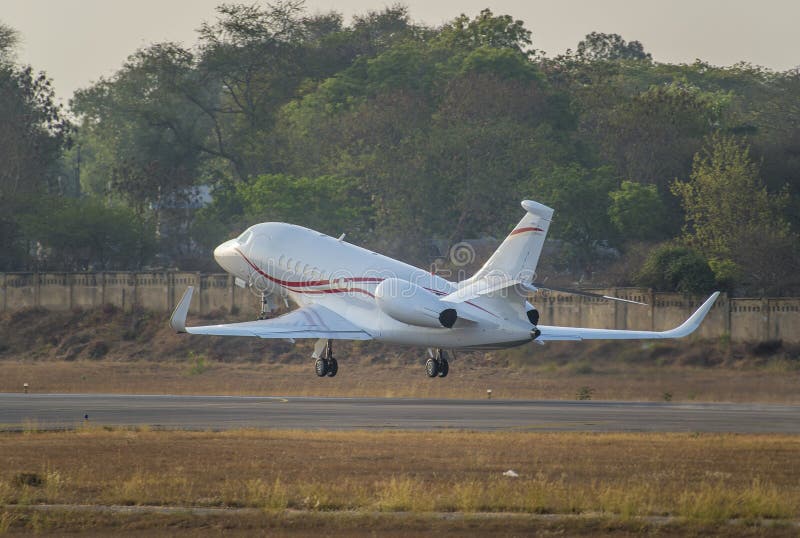 Corporate jet taking off stock image. Image of sunny - 69872397