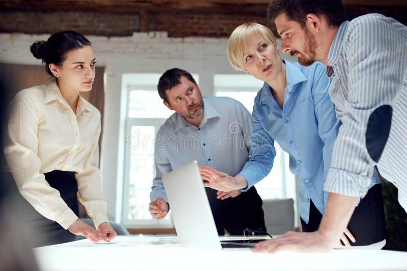 CEO Doing Presentation for Young Team Entrepreneurs, Using Laptop with ...