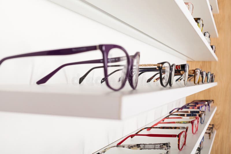 Fashionable Corrective Eye Glasses on a Shelf in Optical Store. Optics ...