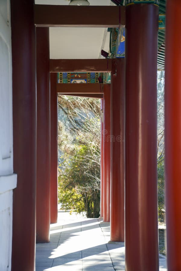 The Corridor is Flanked by Tall Red Columns in a School Stock Image ...