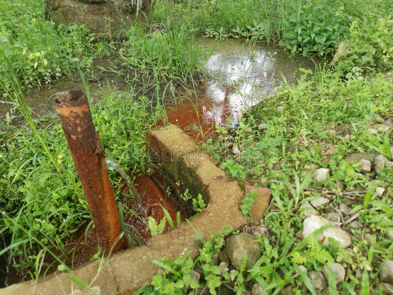 Corroded Water Pipe Leaking in the Farm Meadow. Stock Image - Image of ...