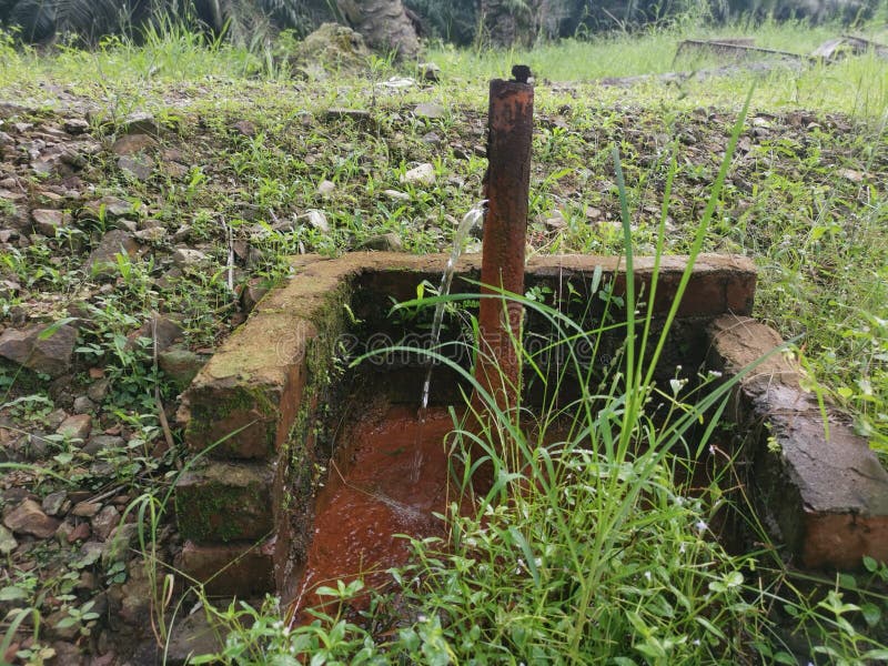 Corroded Water Pipe Leaking in the Farm Meadow. Stock Photo - Image of ...