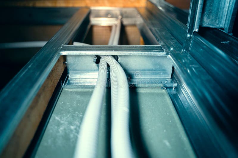 A Corrugated Pipe with Wires Passes through a Metal Profile in a ...