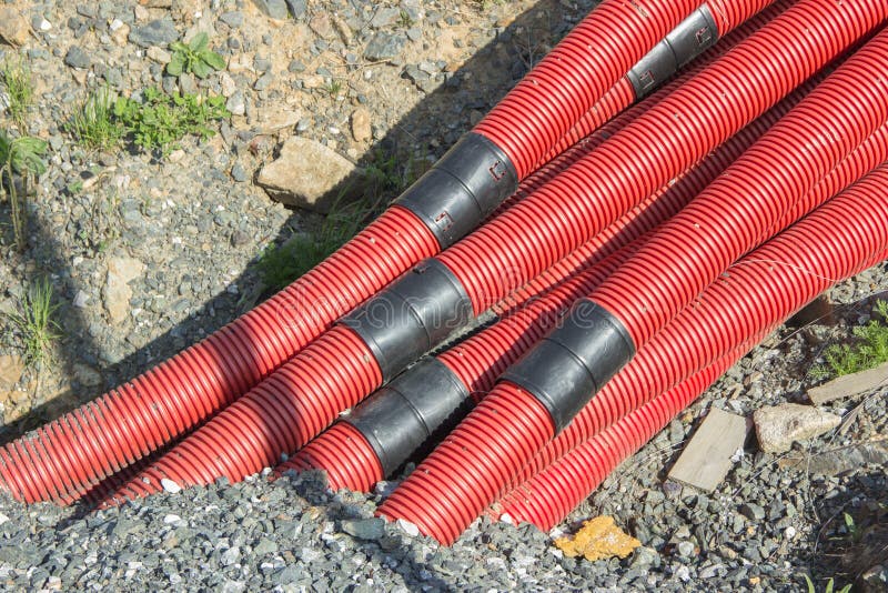 Corrugated Pipes Red with Black Connectors Out of the Soil on Th Stock ...