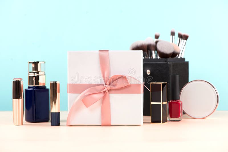 Cosmetics with a Present Box Over Blue Background. Stock Photo - Image ...