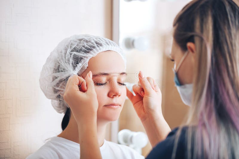 Cosmetolog Beauty Master Making Marks with a Thread before the ...